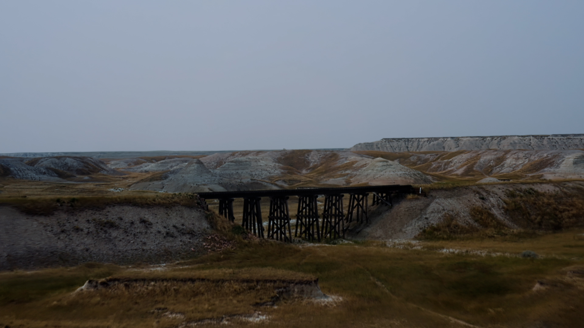 Drone flies towards a bridge in Badlands National Park - shineStock